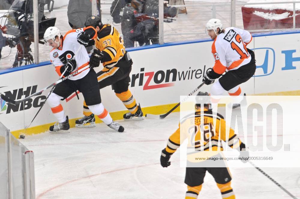 01 January 2010: Right wing Claude Giroux 28 tries to get the puck away ...