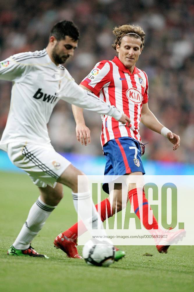 Atletico de Madrid s Diego Forlan against Real Madrid s Raul Albiol ...