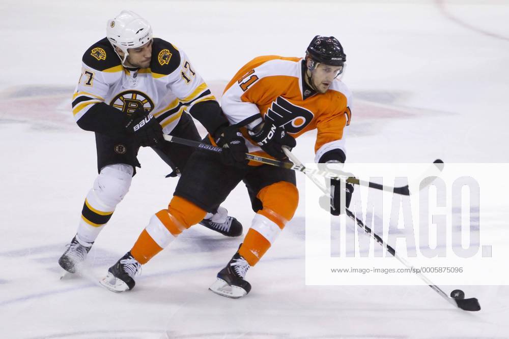 : Boston Bruins left winger Milan Lucic trying to get the puck away ...