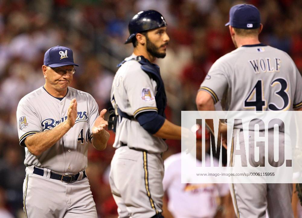 Milwaukee Brewers manager Ken Macha (L) claps as he prepares to take ...