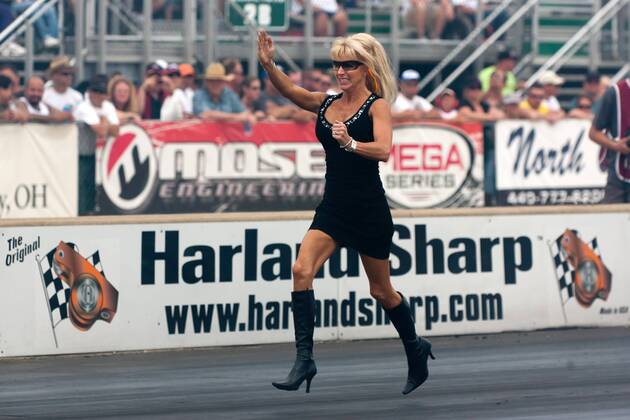Norwalk, Ohio, U.S - Alice Bode, wife of Bob Bode, guides her husband s Fuel Funny Car back to the