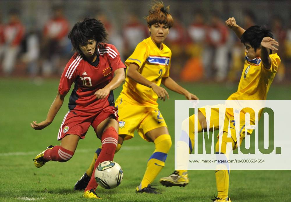 JINAN, Sept. 5, 2011 Han Duan of China drives the ball past players of ...