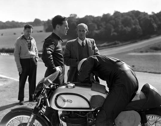 Geoff Duke, British world road racing motorcycle champion, relaxes and ...