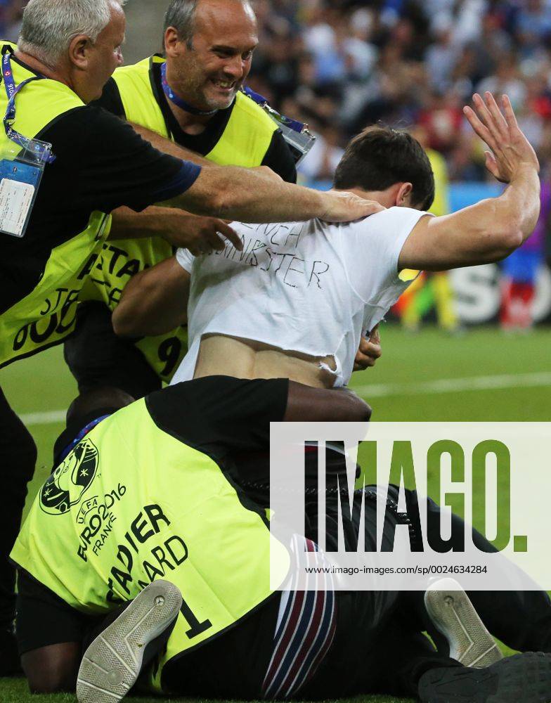 SAINT-DENIS, FRANCE - JULY 10, 2016: Security guards tackle a pitch ...