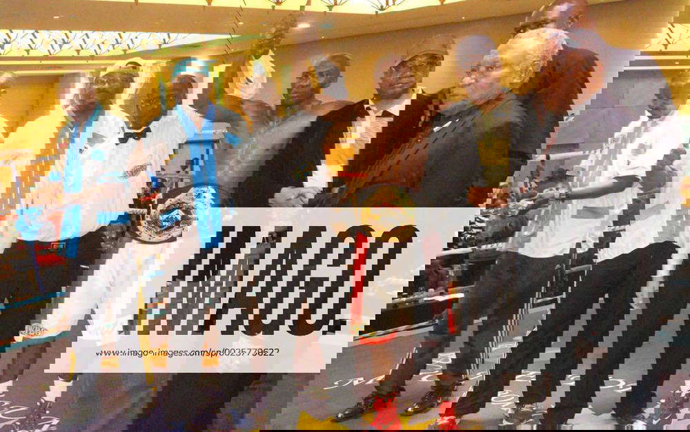 WINDHOEK, -- Namibian boxer Paulus Moses (C) receives his belt after ...