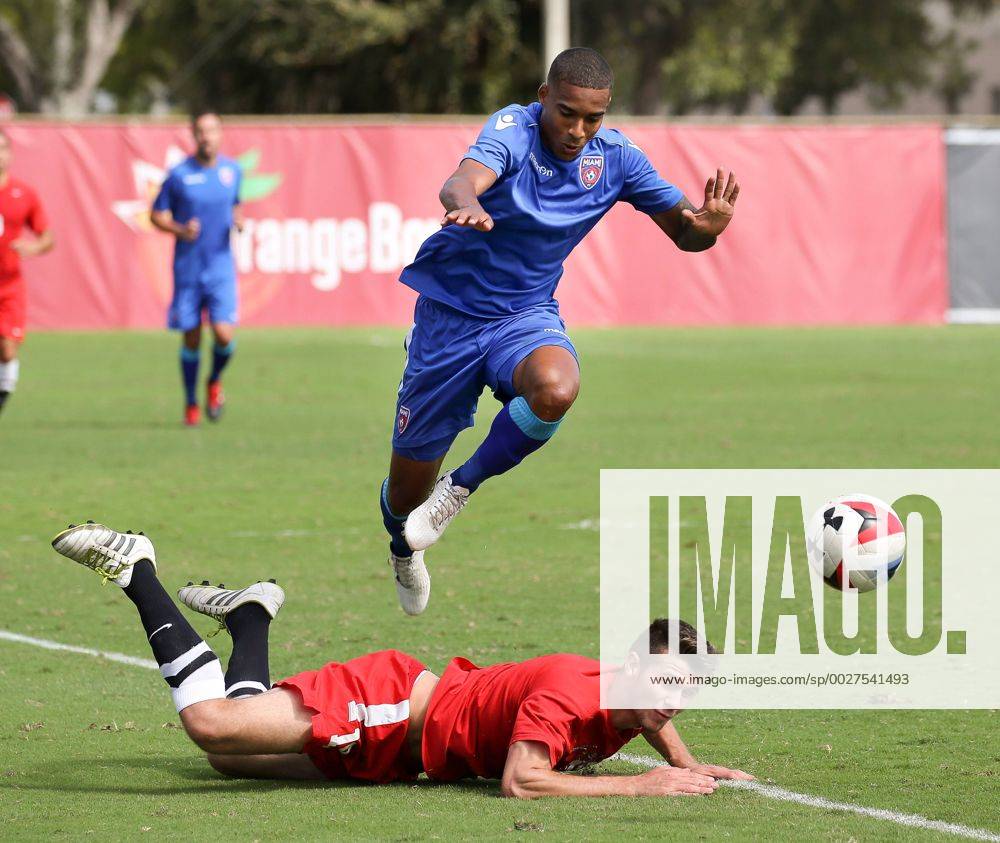 : Miami FC forward Stefano Pinho jumps over Barry University defender ...