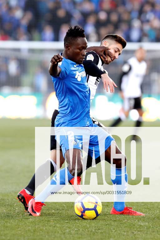 Getafe CF s Djene Dakonam (L) duels for the ball with Valencia CF s ...