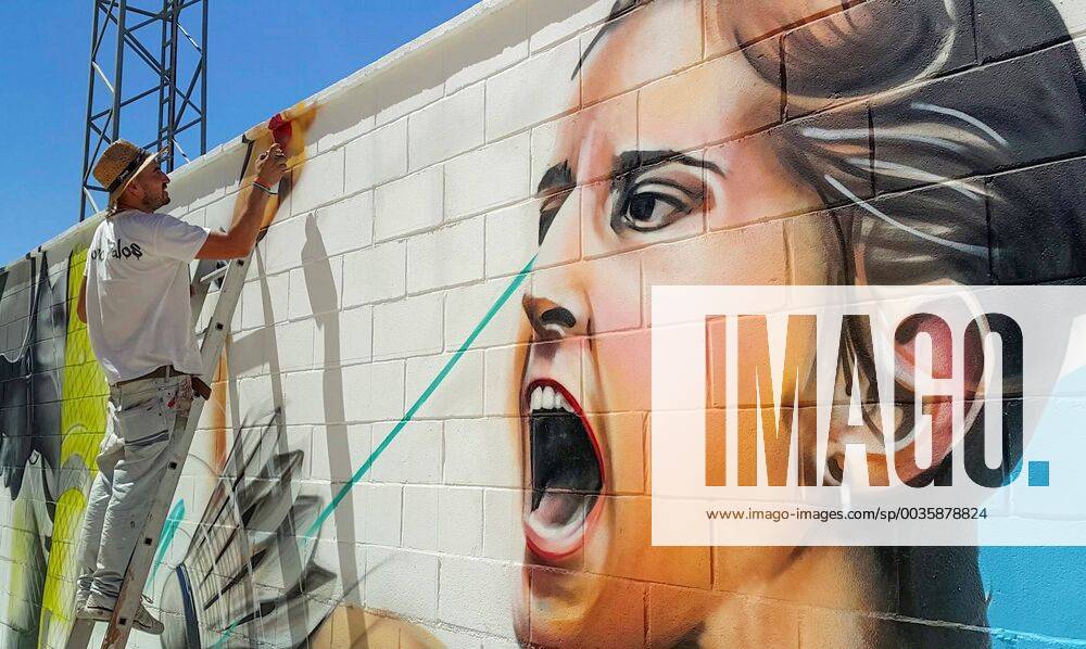 Spanish artist Jacobo Palos works in a mural at La Palma del Condado ...