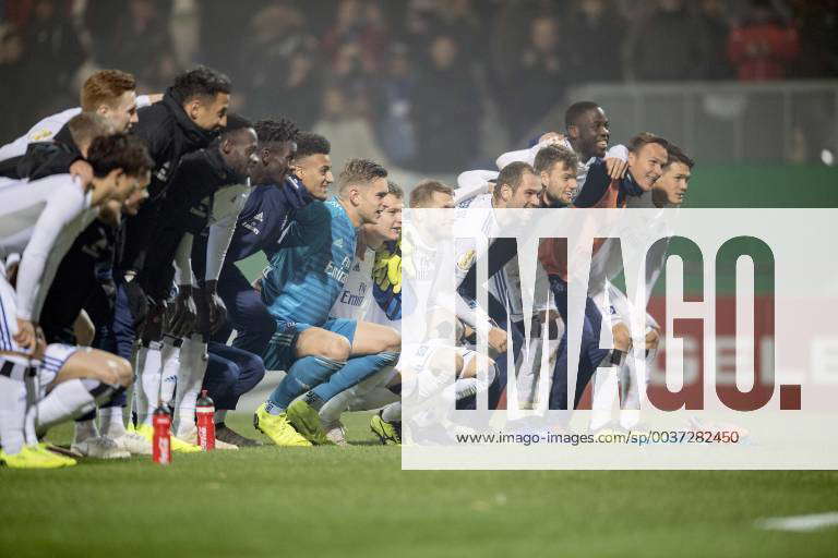 Final victory Team HH the players crouch arm in arm in front of the ...