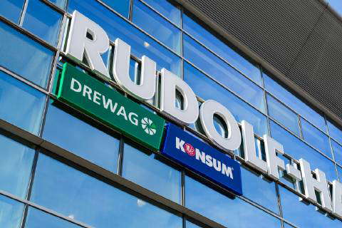 Logos of the sponsors KONSUM Dresden and DREWAG on the glass facade of ...