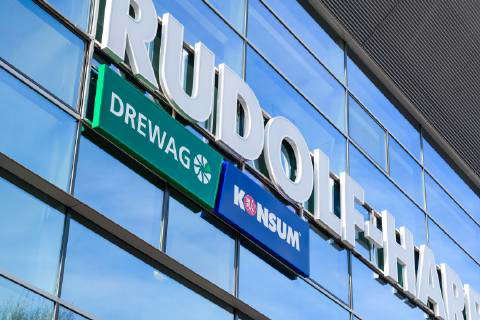 Logos of the sponsors KONSUM Dresden and DREWAG on the glass facade of ...