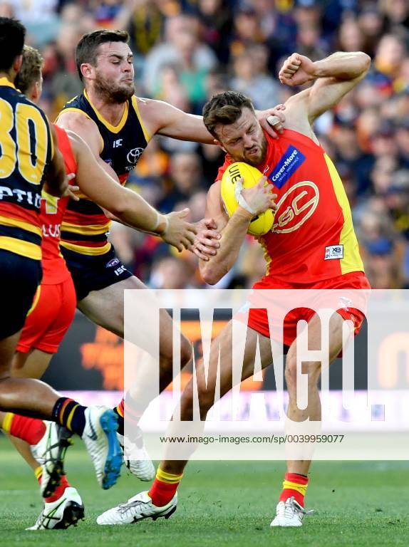 AFL CROWS SUNS, Jordan Murdoch of the Gold Coast Suns is tackled by ...