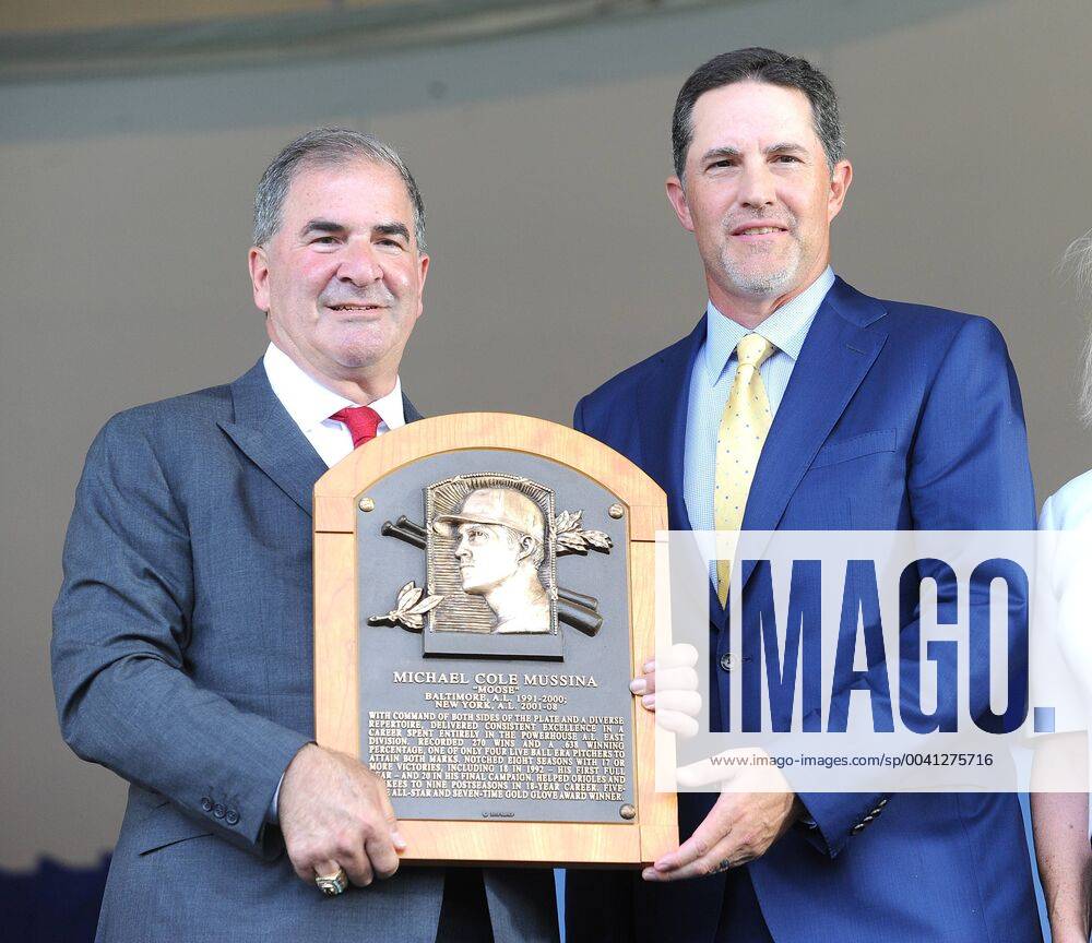 Tim Mead and Mike Mussina hold the Hall of Fame plaque. Harold Baines ...