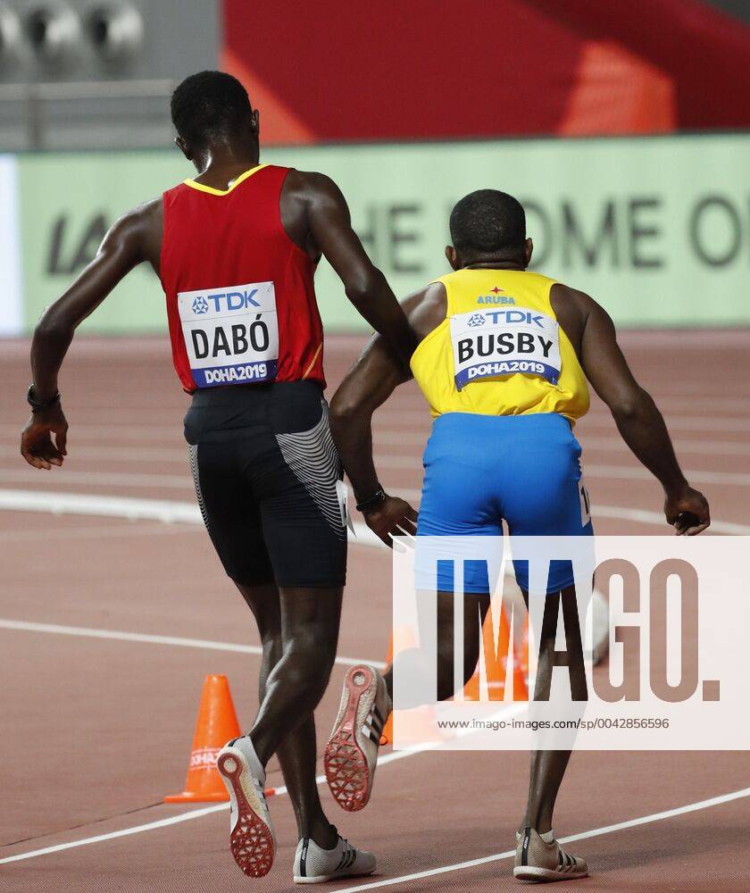 Jonathan Busby (R) of Aruba is helped by Braima Suncar Dabo (L) of ...
