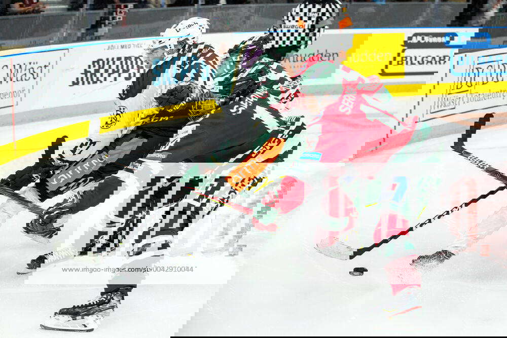 190928 Färjestads Oskar Bäck and Frölundas Lucas Raymond during the ice ...