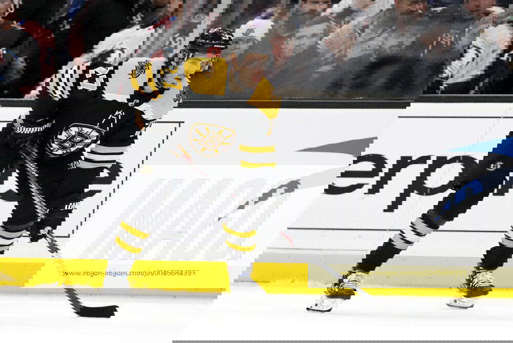 BOSTON, MA - DECEMBER 07: Boston Bruins defenseman John Moore (27) eyes a face off during a game