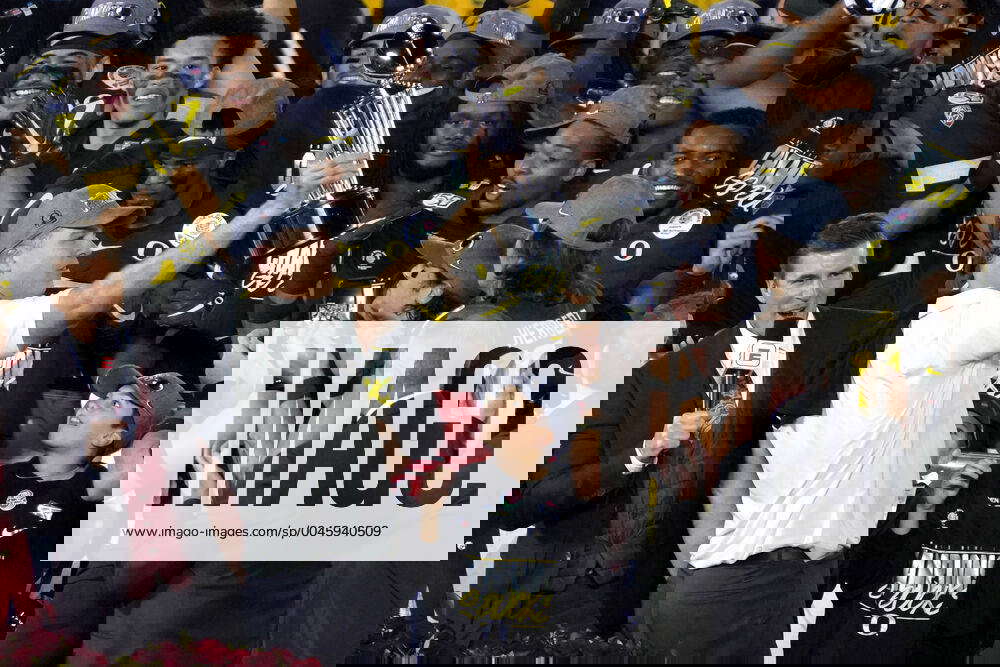 Oregon Ducks head coach Mario Cristobal holds up the Leishman Trophy to ...