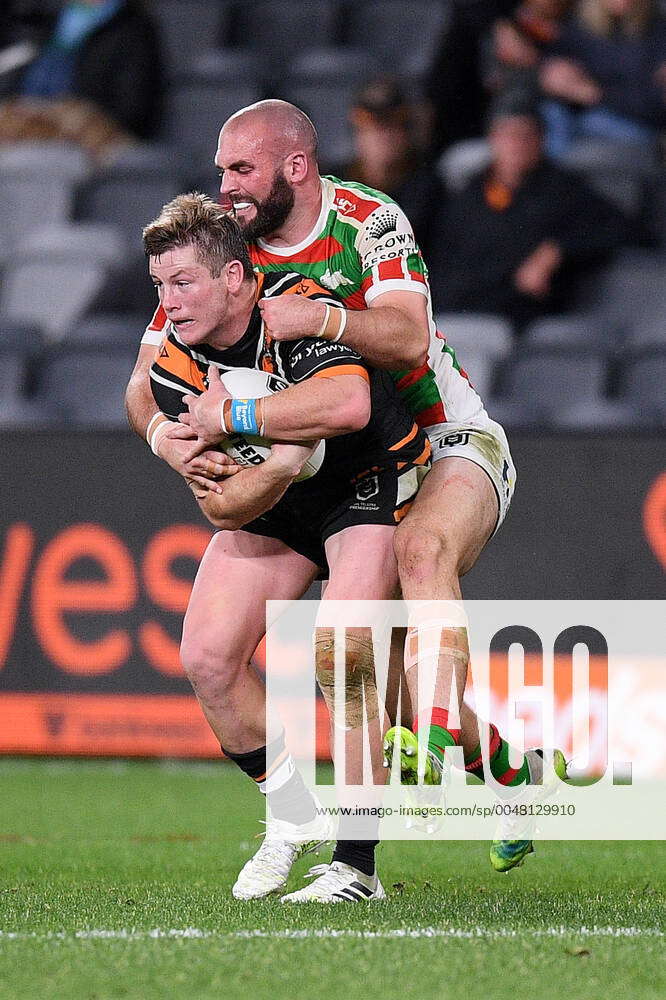 NRL TIGERS RABBITOHS, Harry Grant of the Tigers is tackled by Mark ...