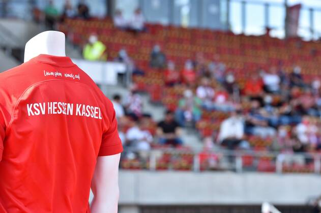 Spectators with mask and distance on the tribune, corner flag, logo ...