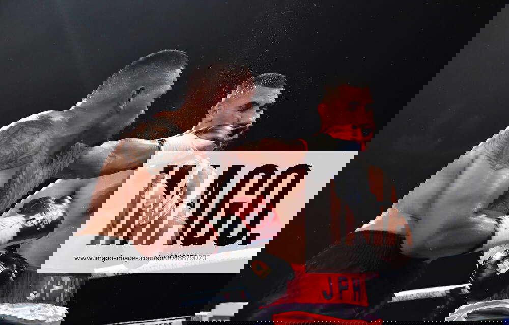 BOXING HUNI OPELU, Faiga Django Opelu (left) lands a punch on Justis ...