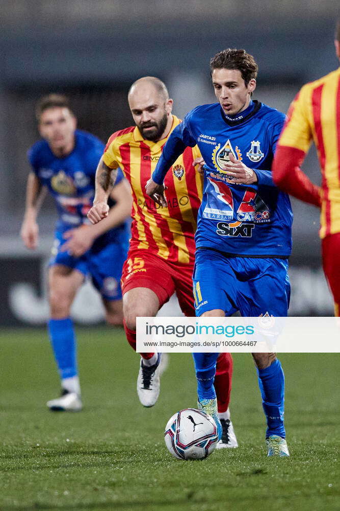 Juri Cisotti (C) of Sliema Wanderers speeds past Dion Fava (L) of ...