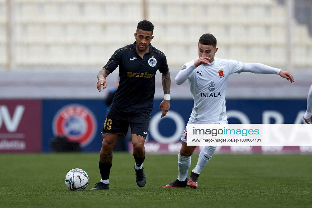 Gilmar Ribeiro Da Silva (L) of Hibernians shields the ball away from ...