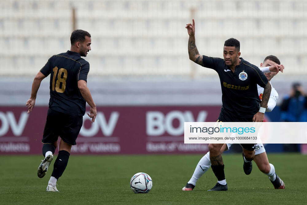 Gilmar Ribeiro Da Silva (2nd R) of Hibernians shields the ball away ...