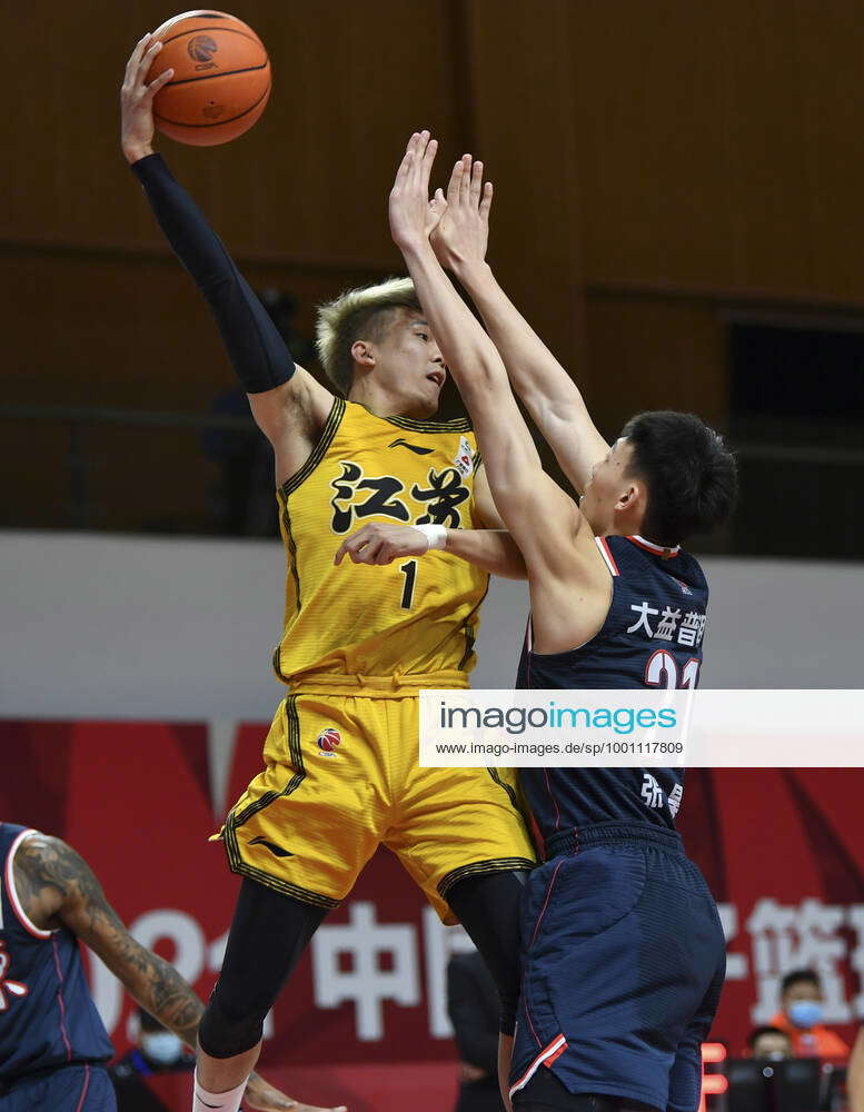 ZHUJI, Huang Rongqi of Jiangsu Dragons jumps to pass the ball during ...