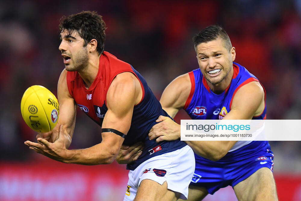AFL BULLDOGS DEMONS, Christian Petracca (left) of Melbourne Demons give ...