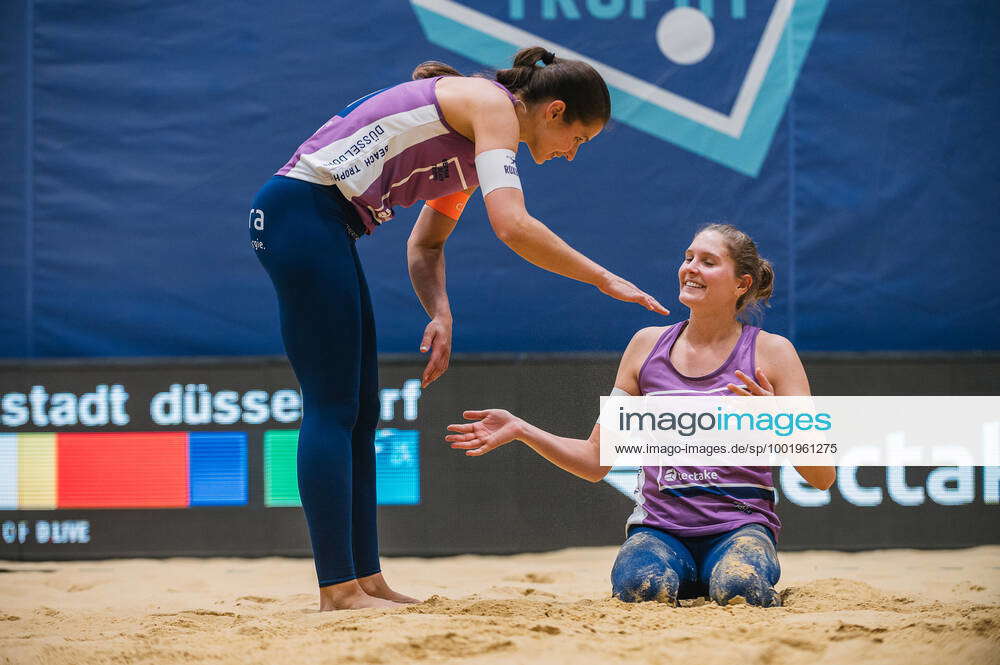 Sarah Schulz sits in the sand, Chantal Laboureur helps her up, final day, beach volleyball, German