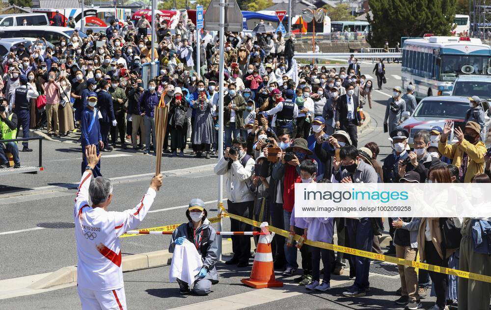Tokyo Olympic torch relay A roadside is jammed with people watching the ...