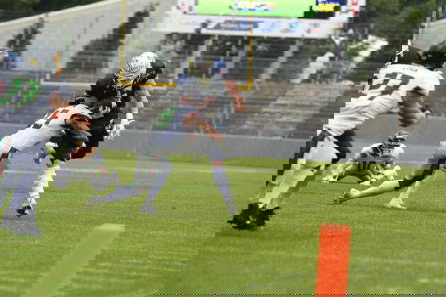 David Meza 5, tight end, Stuttgart Surge is tackled by Niko Lester 25 ...