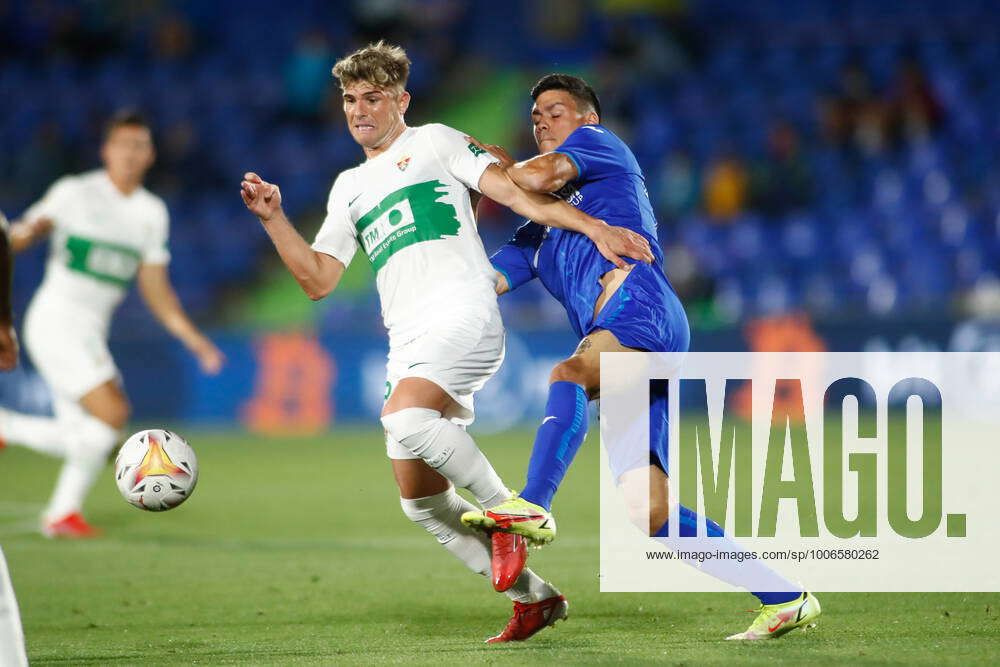 GETAFE, MADRID, SPAIN: Raul Guti of Elche and Jonathan Silva of Getafe ...