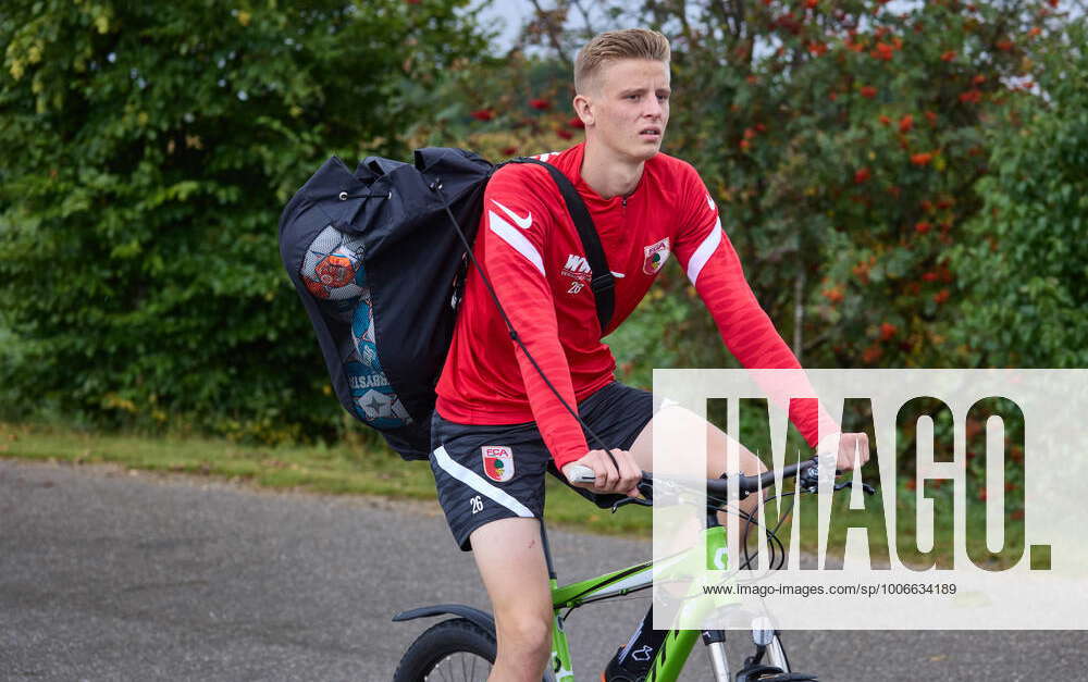 Frederik Winther FC Augsburg 26 on his bike on the way to the training ...