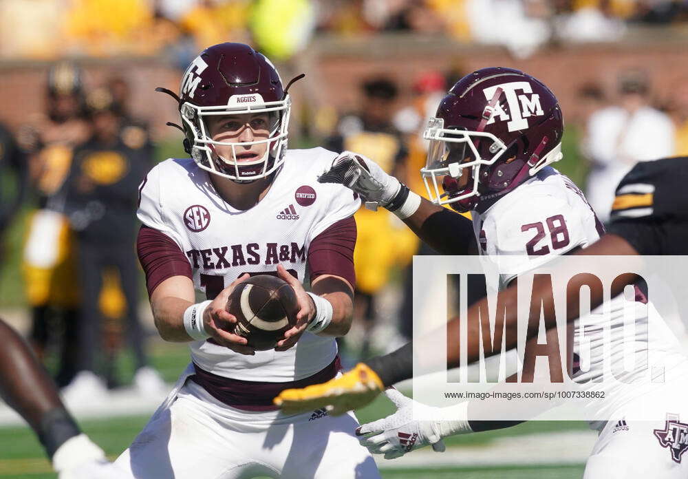 Texas A&M quarterback Zach Calzada hands the football off to Isaiah ...