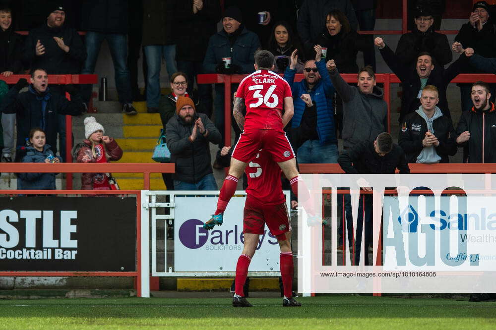 Mitchell Clark jumps on Ross Sykes of Accrington Stanley after scoring ...