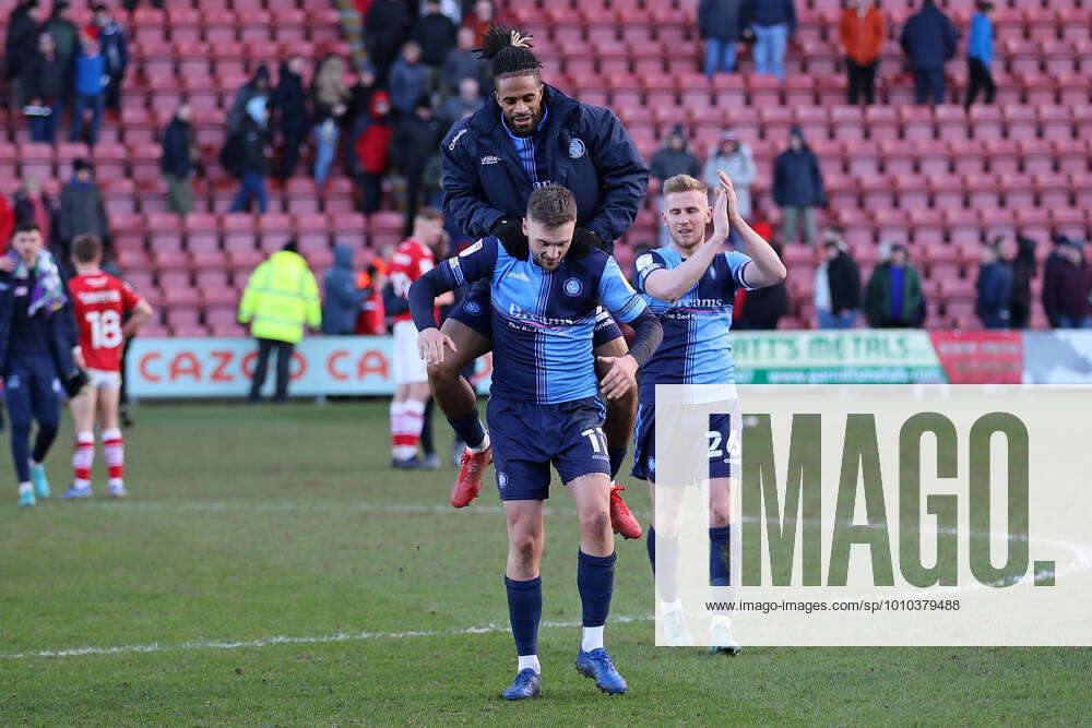 Garath McCleary of Wycombe Wanderers jumps on Lewis Wing of Wycombe ...