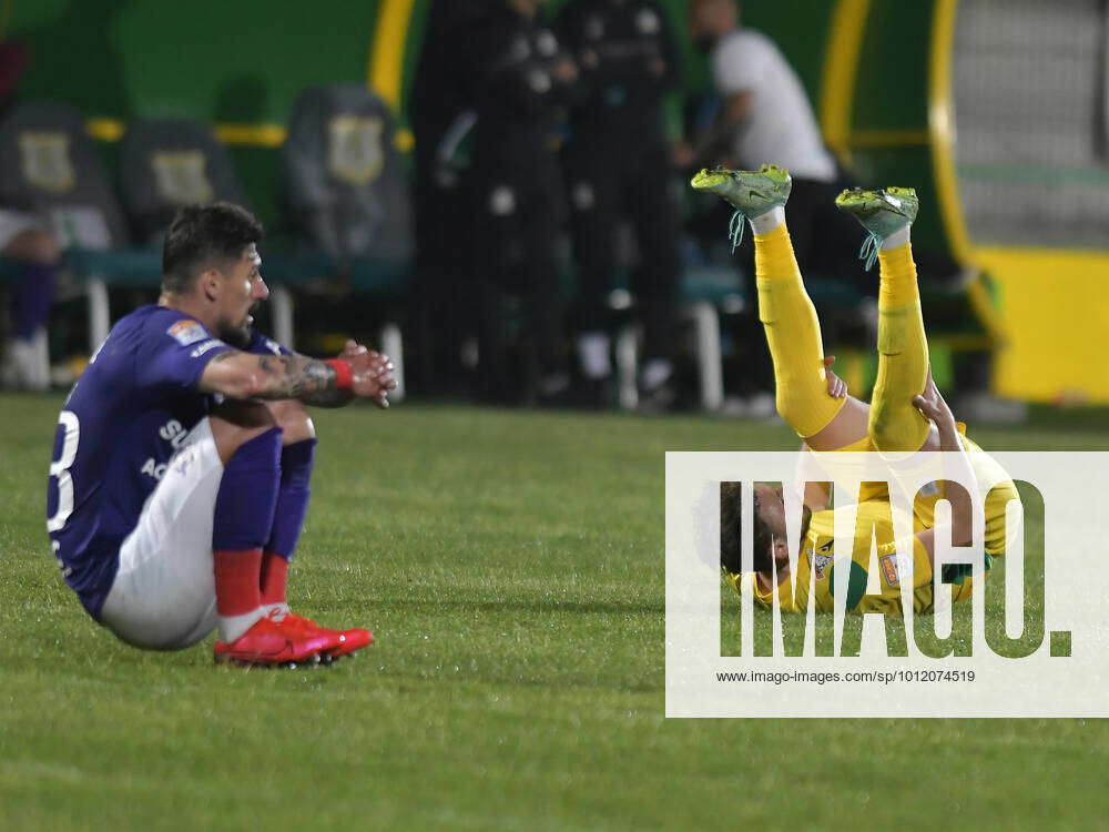 Razvan Alin Trif and Alexandru Cristian Albu on the ground in the football match between CS