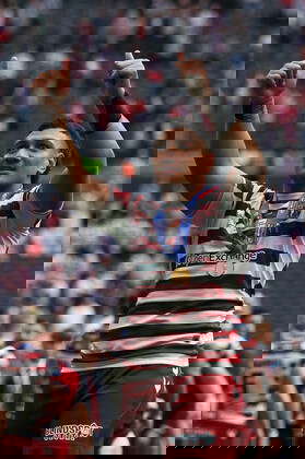 Patrick Mago of Wigan Warriors celebrates with the trophy and team ...