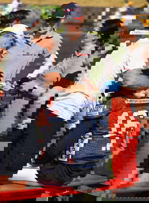 injured quarterback Justin Agner Dresden is treated on the field ...