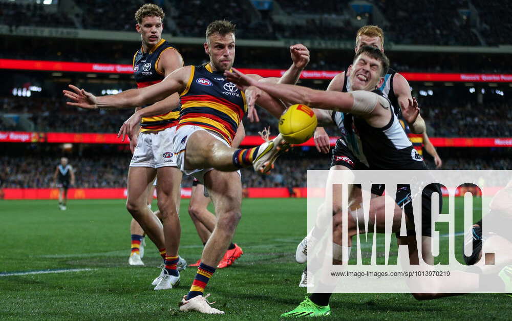 AFL POWER CROWS, Brodie Smith of the Crows has his kick smothered by ...