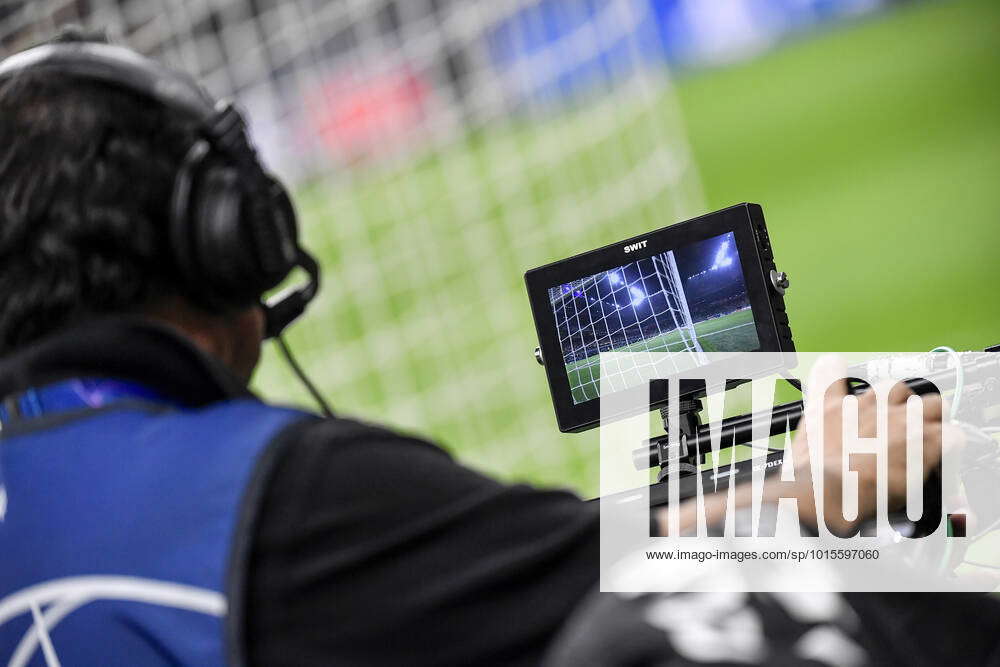 A cameraman watches in the monitor as he shoots with the camera ...