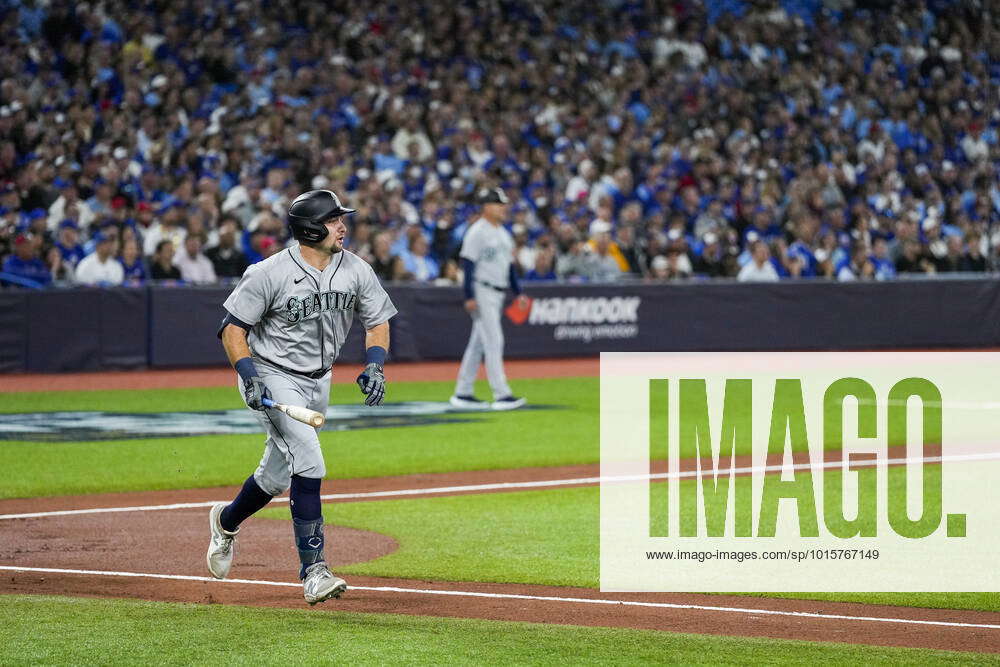 Seattle Mariners catcher Cal Raleigh watches his ball fly over the wall ...