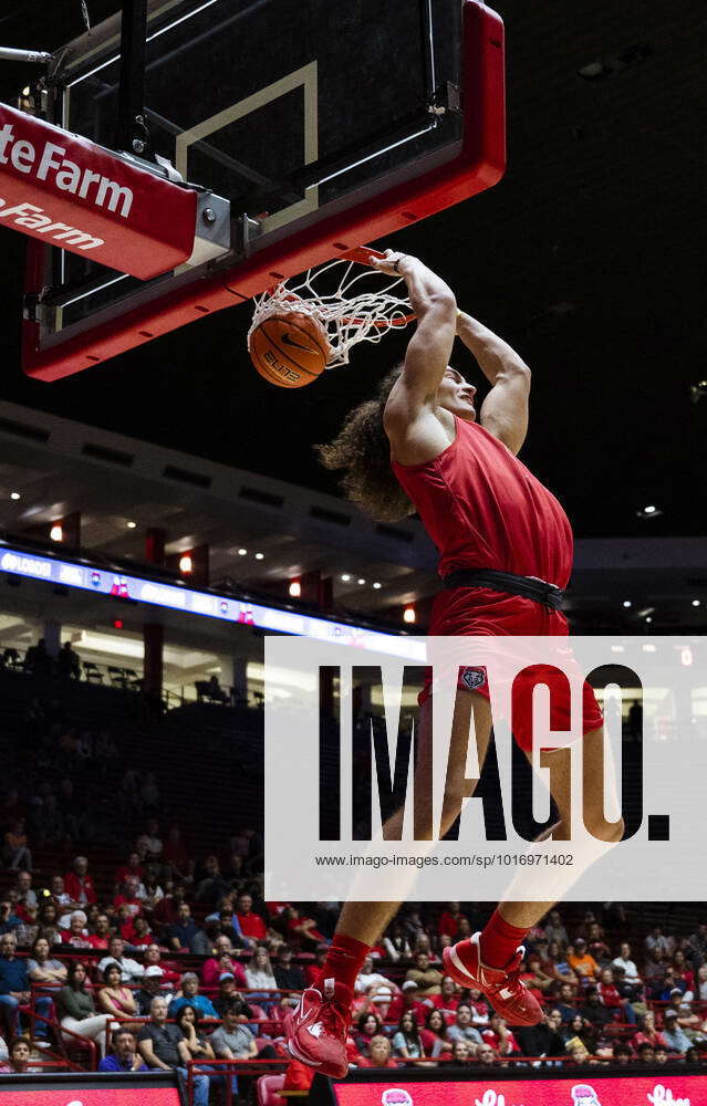 October 21, 2022, USA: UNM senior Josiah Allick (20) hangs from the rim ...