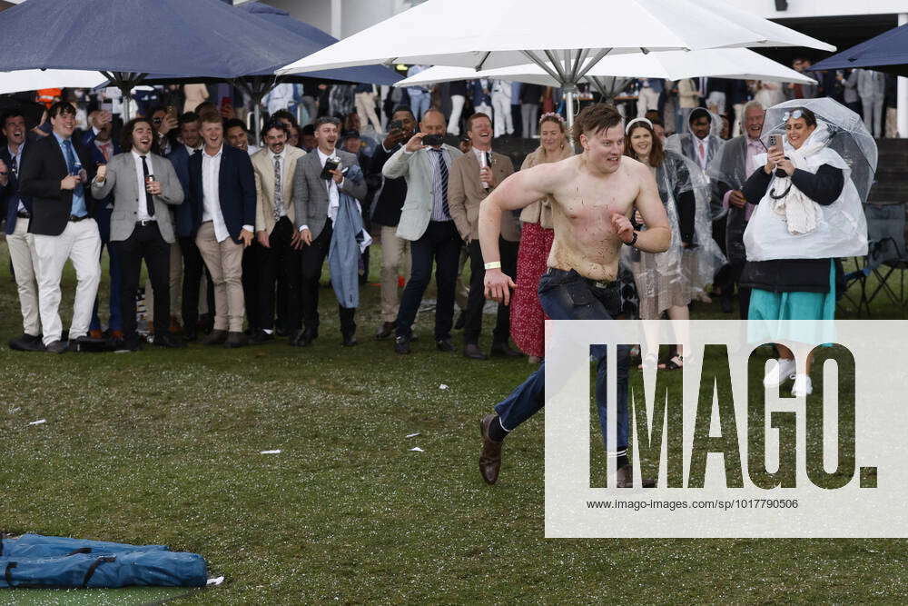 RACING MELBOURNE CUP, A shirtless racegoer clowns around during the ...