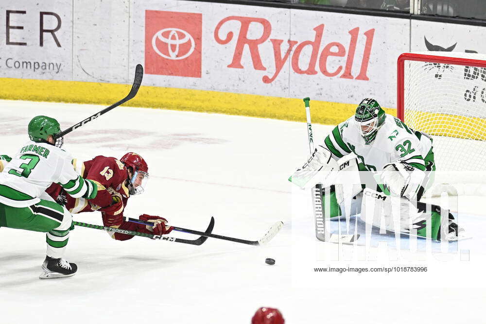 Denver Pioneers forward Massimo Rizzo (13) attempts to direct a puck ...