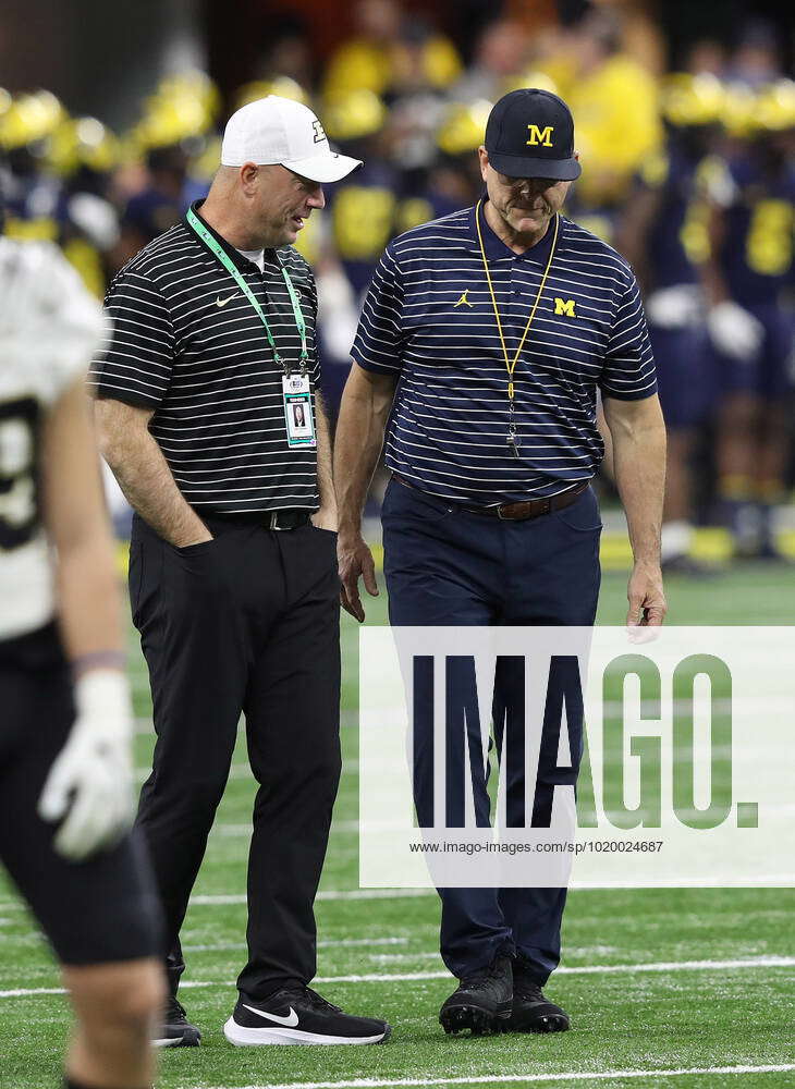 Michigan Wolverines head coach Jim Harbaugh talks with Purdue ...