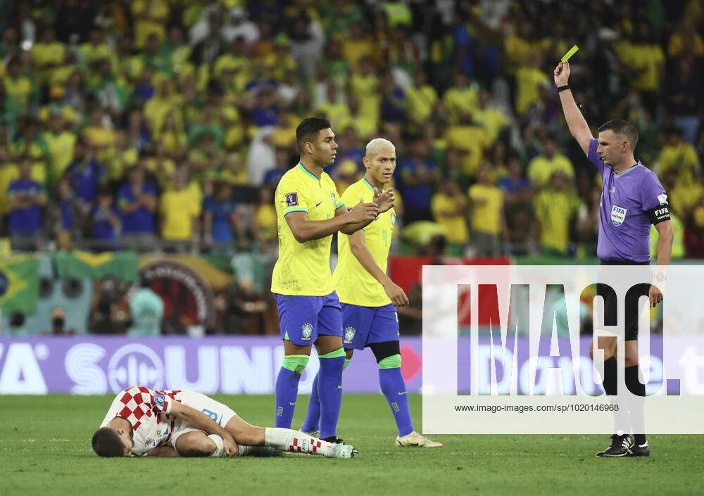 (221209) -- AL RAYYAN, Dec. 9, 2022 -- Referee Michael Oliver (R) shows a yellow card to Casemiro