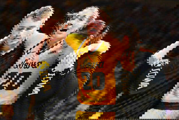 IOWA CITY, IOWA - DECEMBER 07: Iowa guard Kate Martin is helped off of ...