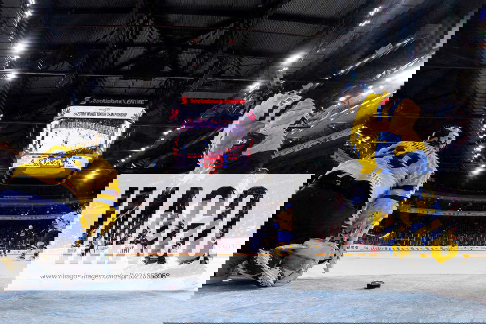 Goaltender Carl Lindbom and Axel Sandin Pellikka of Sweden look ...